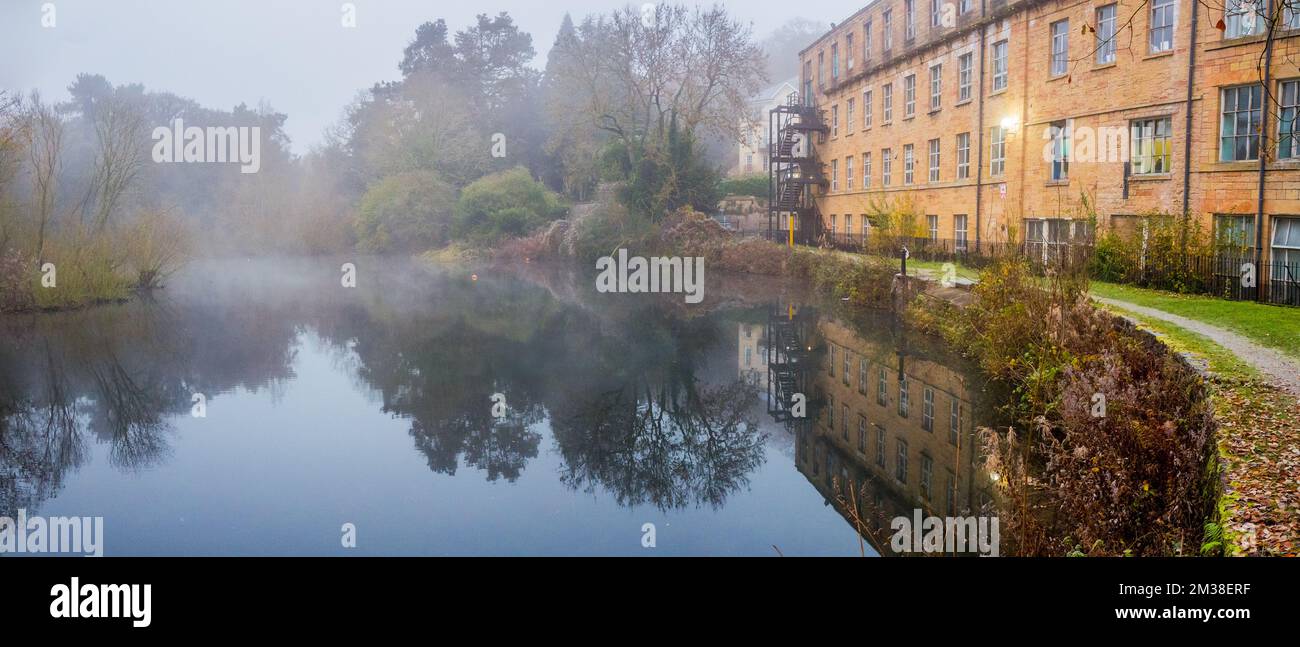 The stone built 18th. century Viyella textile mill with mist forming on ...