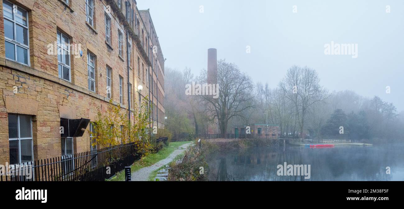 The stone built 18th. century Viyella textile mill with mist forming on ...
