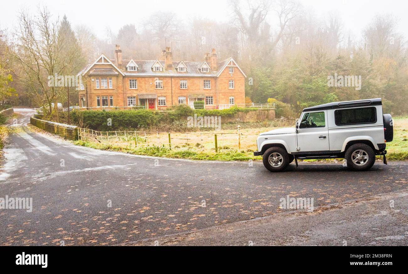 Parked white Landrover Defender 90 county model on a quite country lane ...