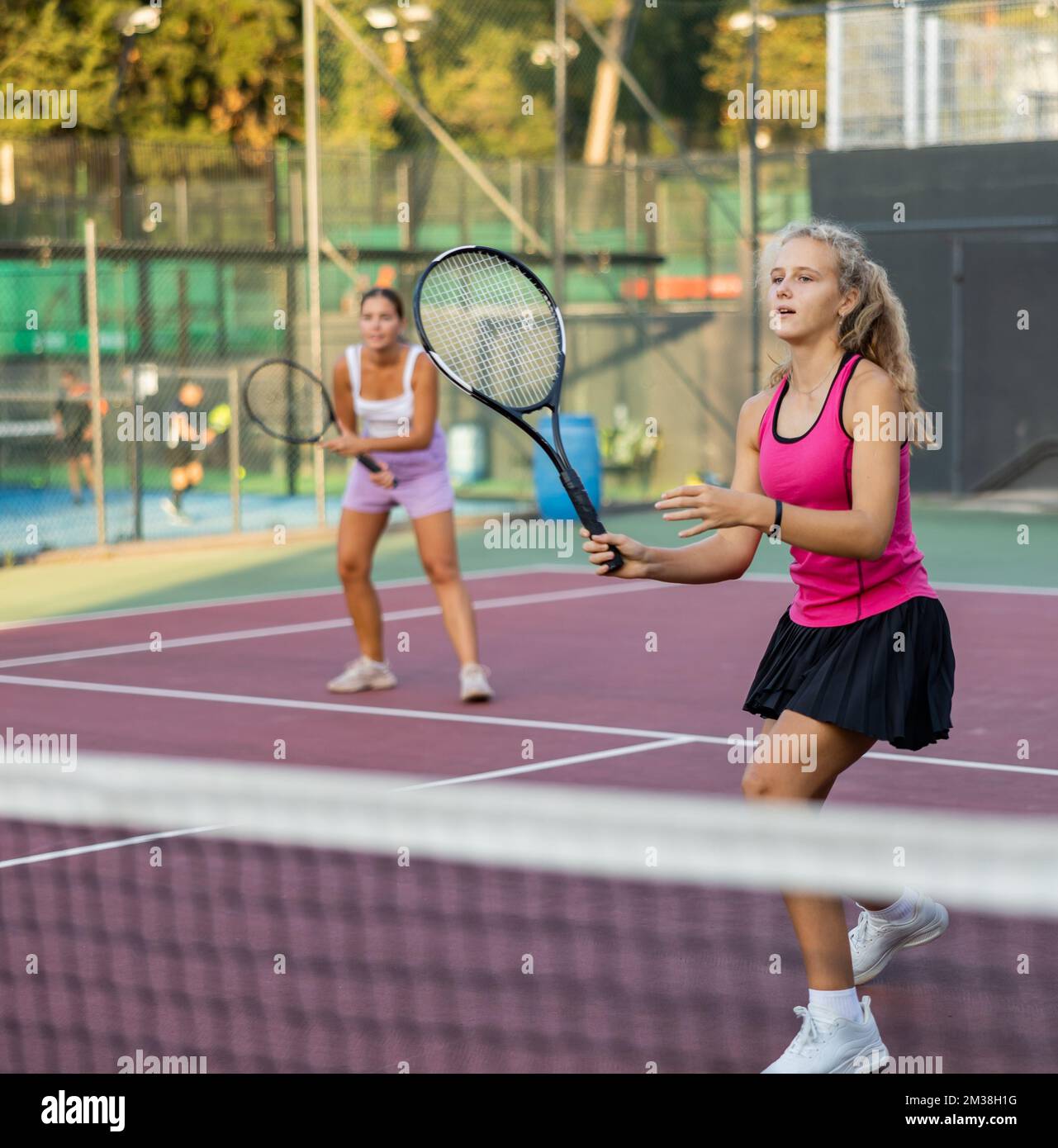 Portrait of emotional woman tennis player during friendly doubles ...