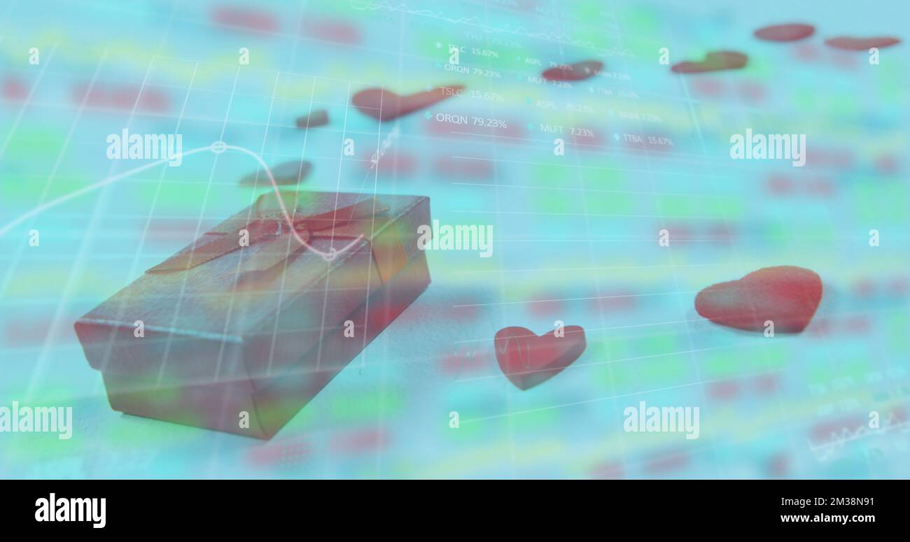 Image of gift box and heart shapes over moving graphs and trading board ...