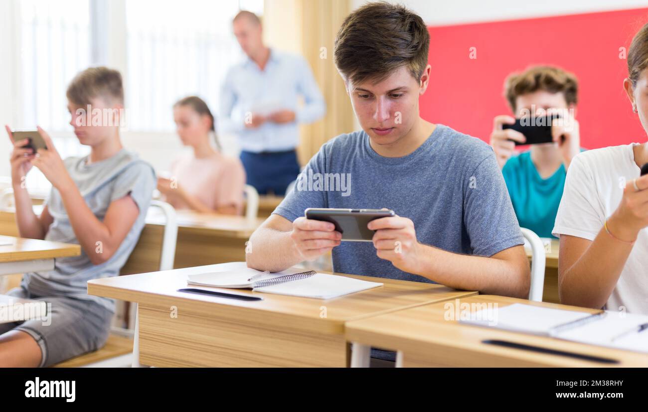 High school student using smartphone on lecture in class Stock Photo ...