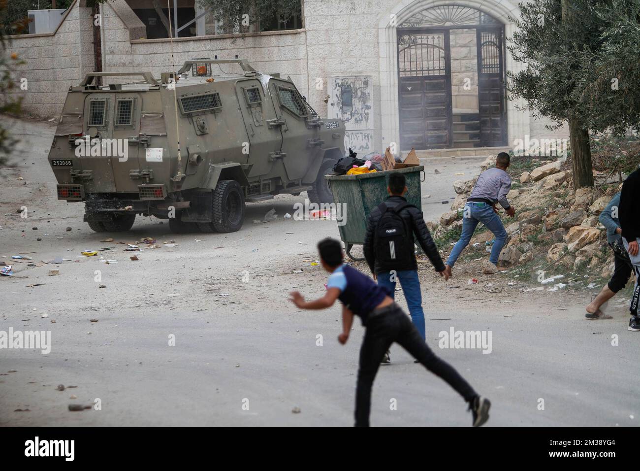 Nablus, Palestine. 14th Dec, 2022. Palestinian youths throw stones at ...