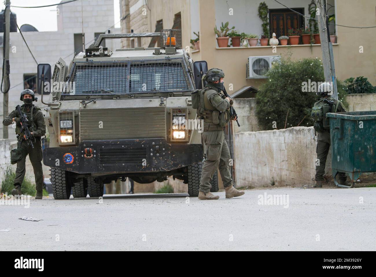 Nablus, Palestine. 14th Dec, 2022. Israeli army forces surround a house ...