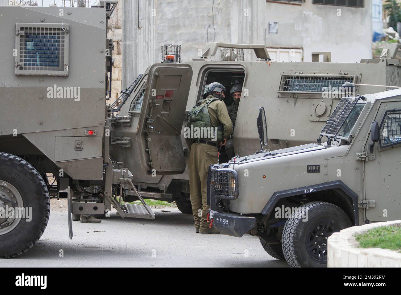 Israeli army forces surround a house of wanted Palestinian during a raid in the village of Salem ...