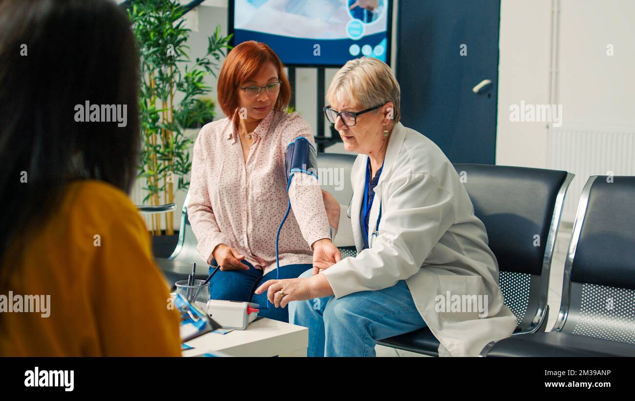 Physician checking blood and pulse pressure with tonometer, doing ...