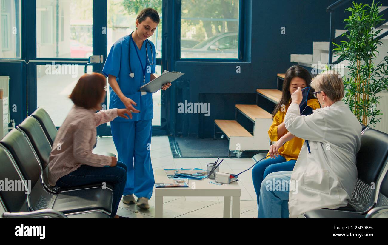 Senior doctor measuring hypertension with tonometer on asian patient ...