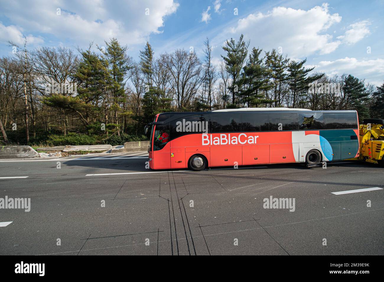 Illustration shows the damaged bus being towed at the scene of a ...