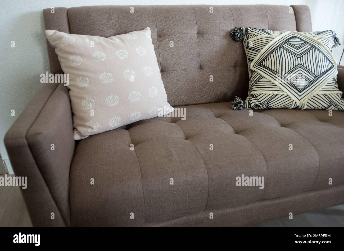 Fabric love seat couch with fall autumn pumpkin pillow Stock Photo - Alamy