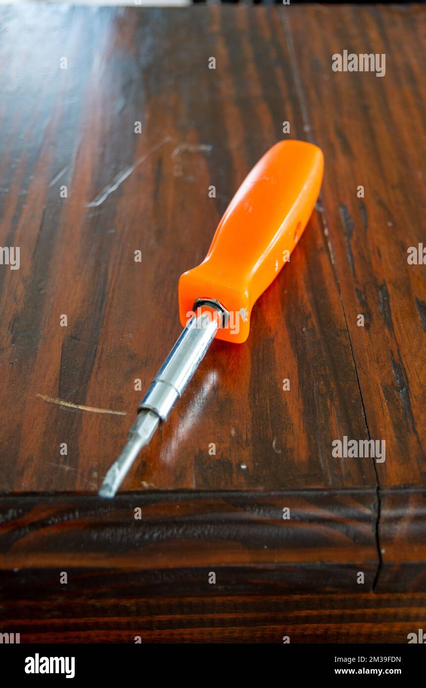 Orange handled metal screw driver Stock Photo - Alamy