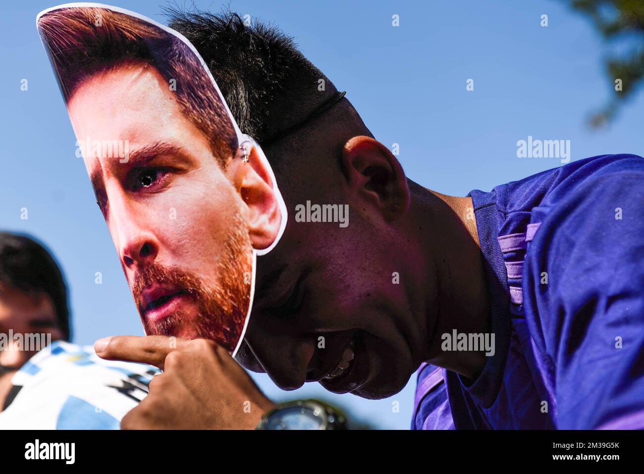An Argentine soccer fan with a Lionel Messi's mask reacts as he watches ...