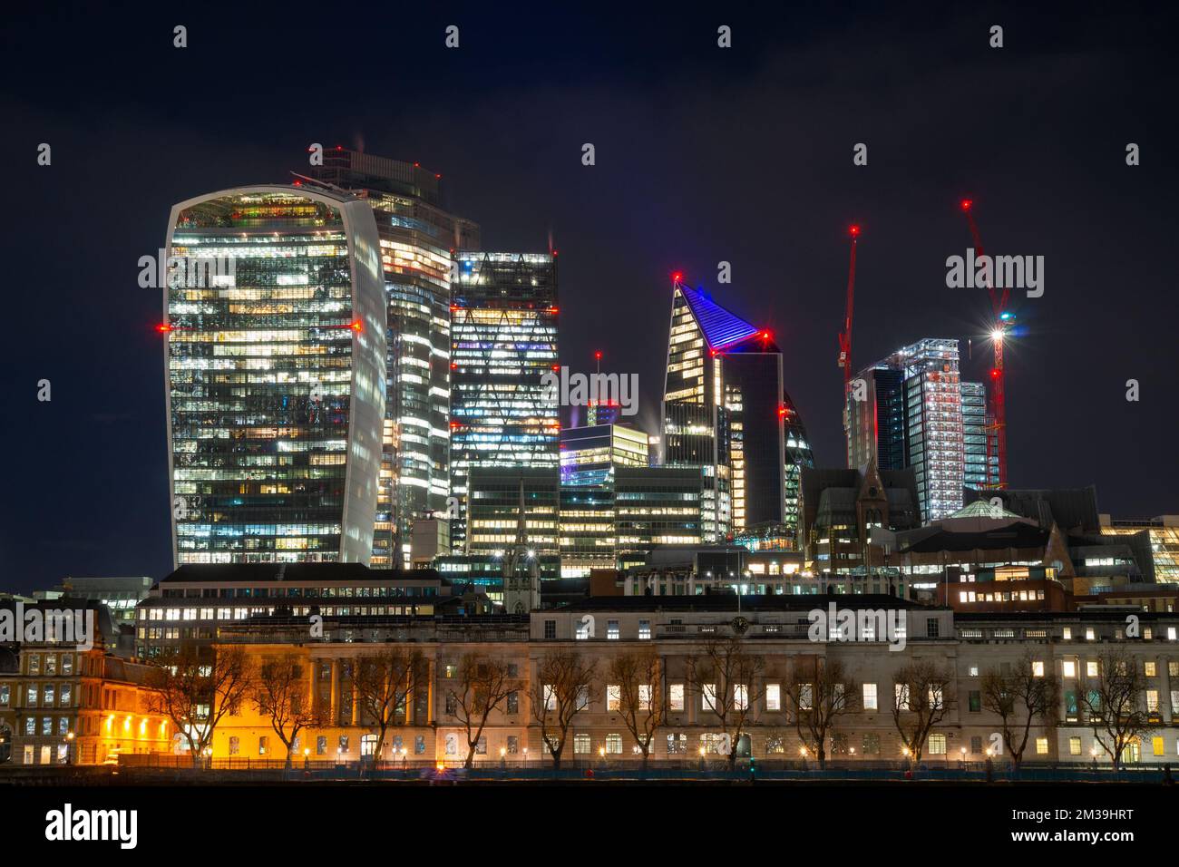 London tower blocks or skyscrapers viewed at night from the south bank ...