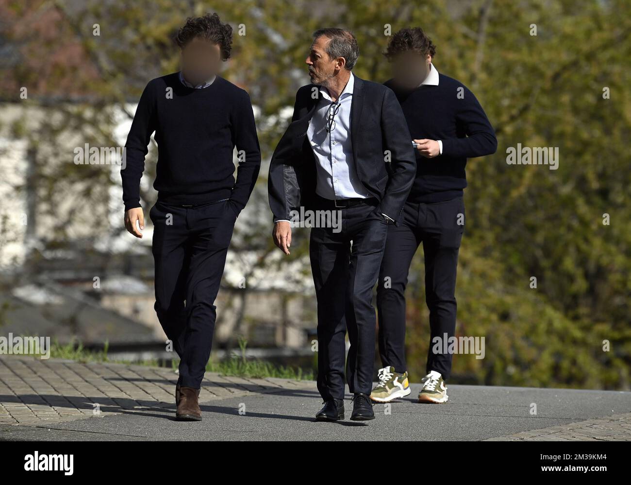 Unidentified arrive at the start of the trial against the 18 members of ...