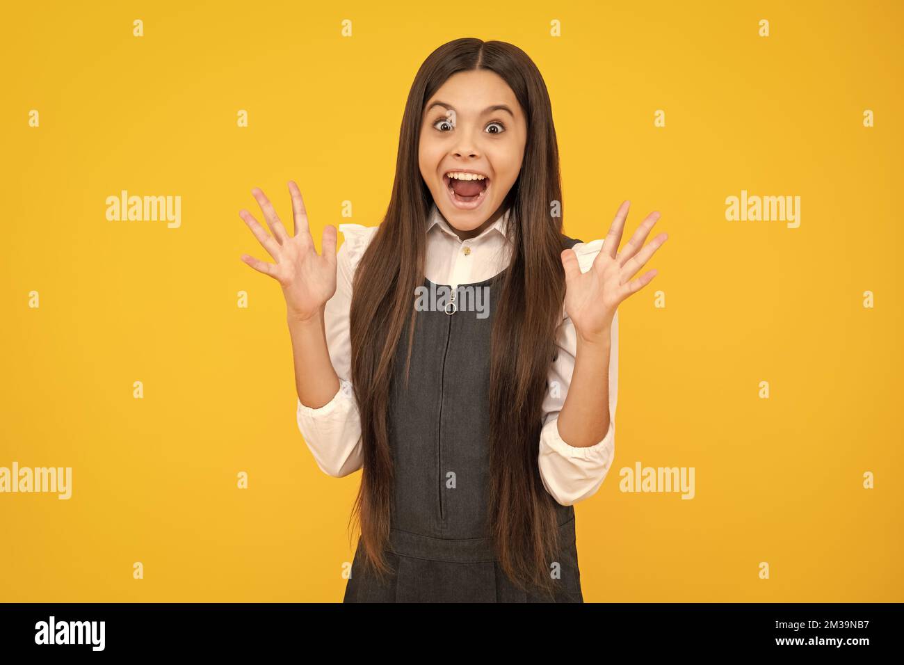 Child with positive expression, joyful and exciting over yellow ...