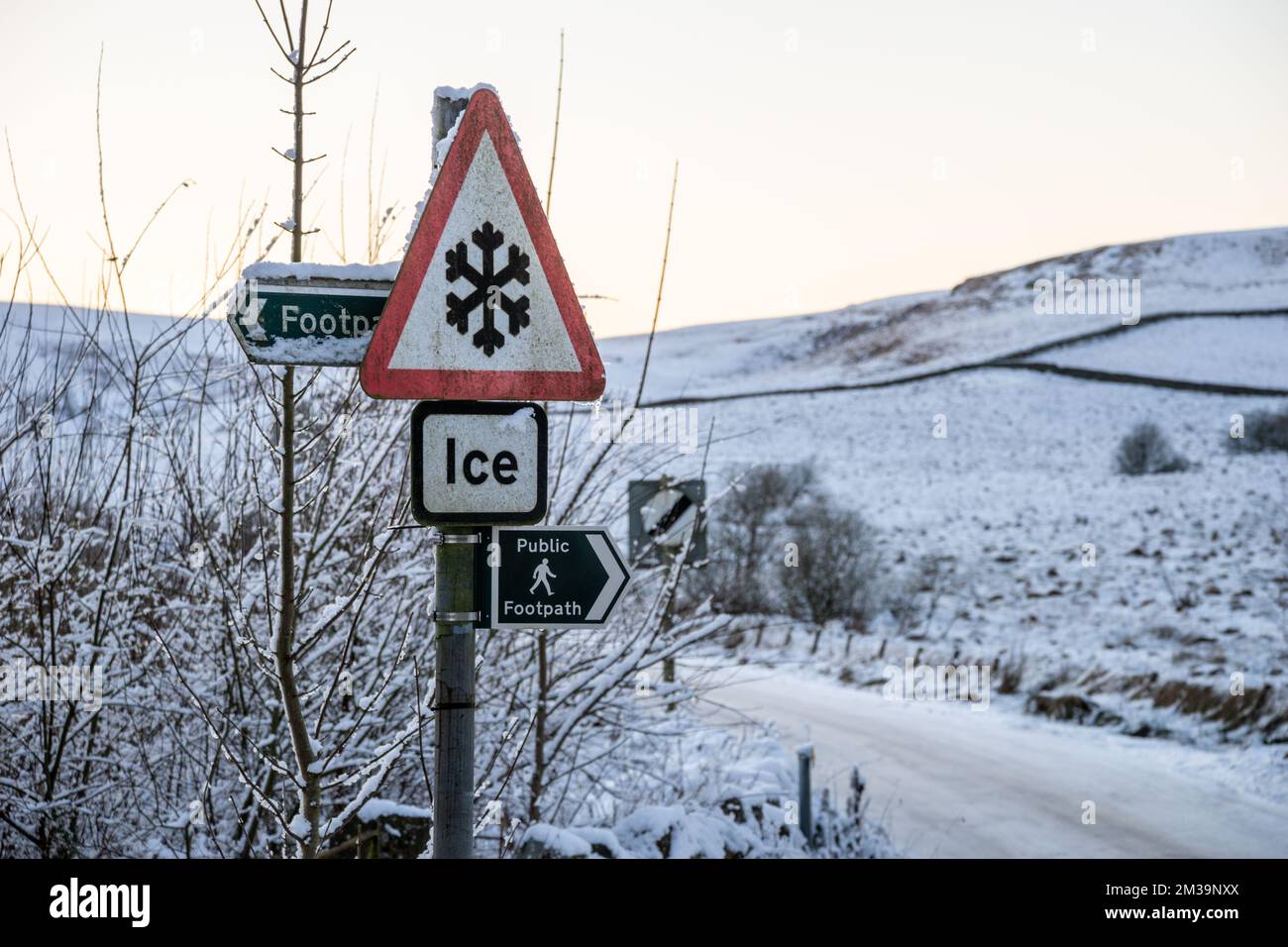 Ice warning sign on an untreated minor road in England, UK, in very ...