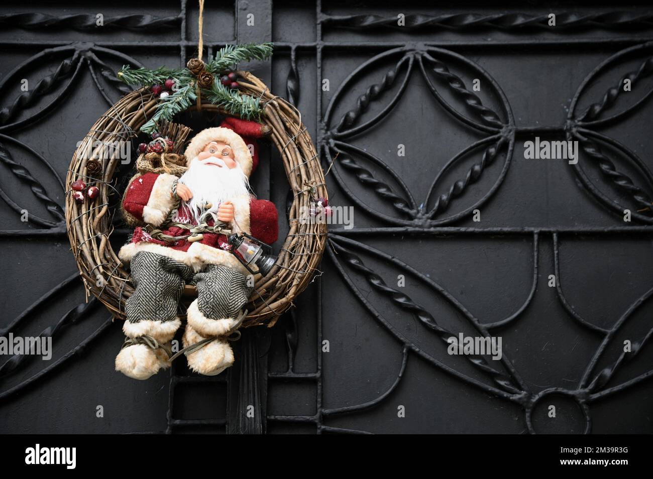 Festive Santa Claus wreath on a wrought iron entrance gate Stock Photo ...