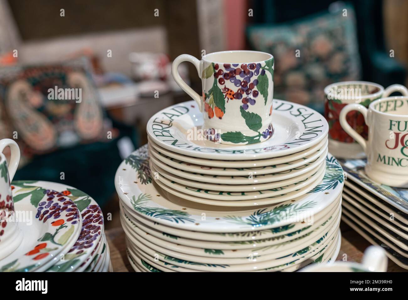 White ceramic plates on a shelf in a store. Designer ceramic plates ...