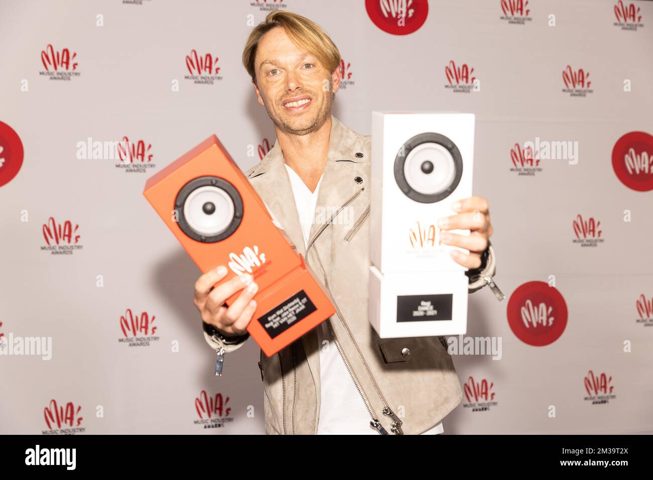 DJ Reginald Regi Penxten poses with awards won at the 14th edition of ...