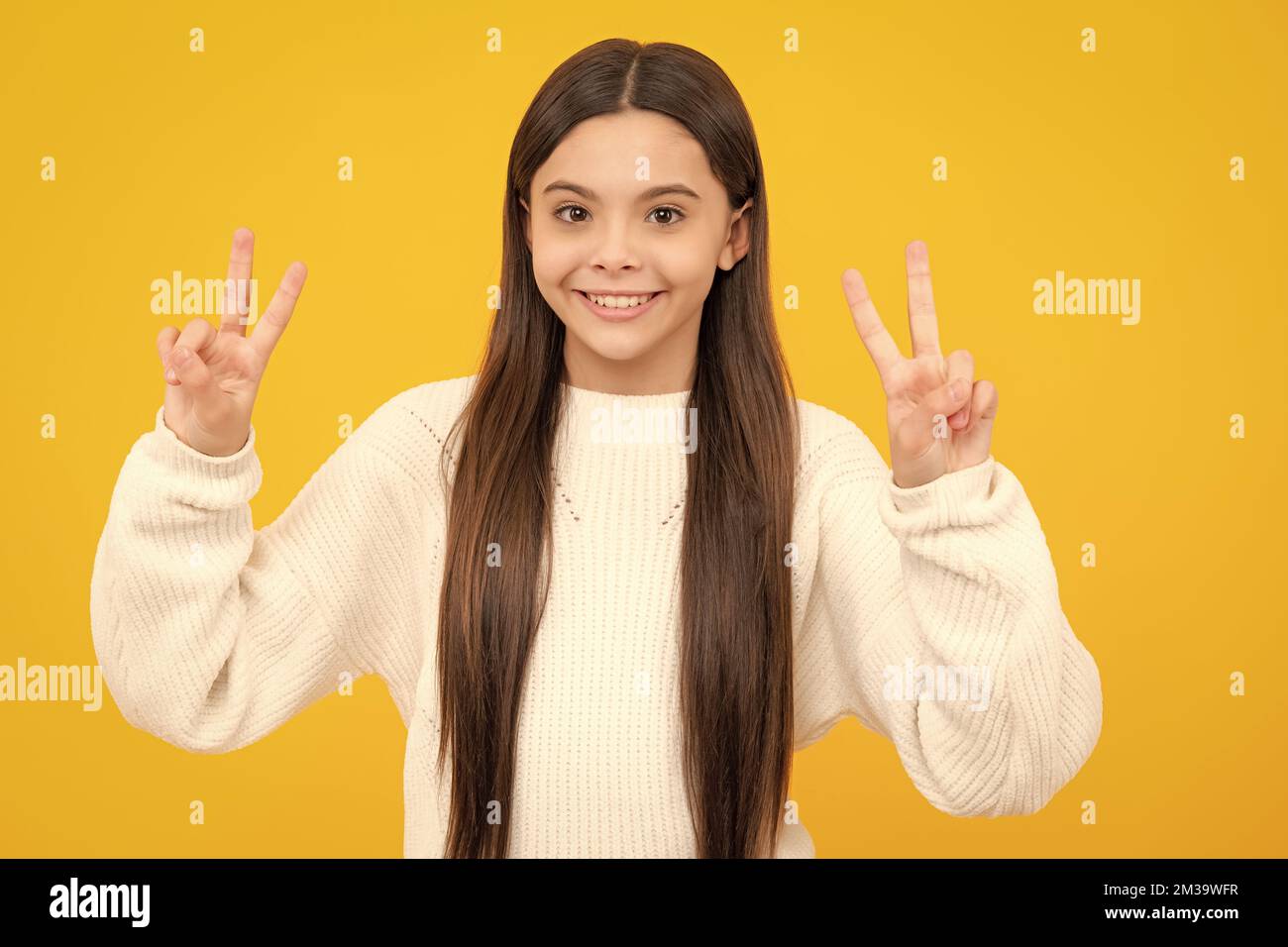 Cute teen girl showing fingers doing victory sign. Number two, v sign ...