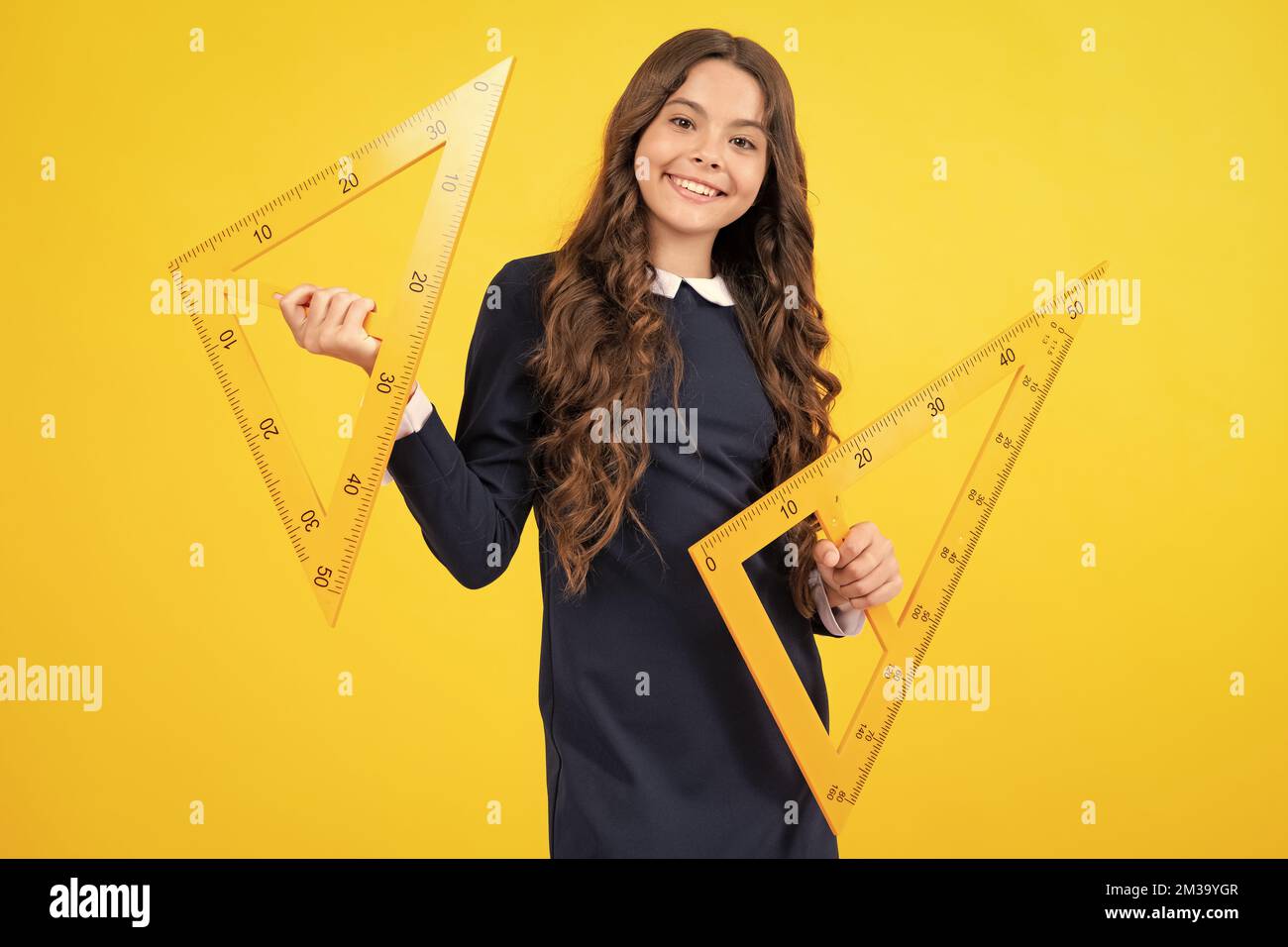 Schoolgirl in school uniform hold mathematics measure. Metric ...
