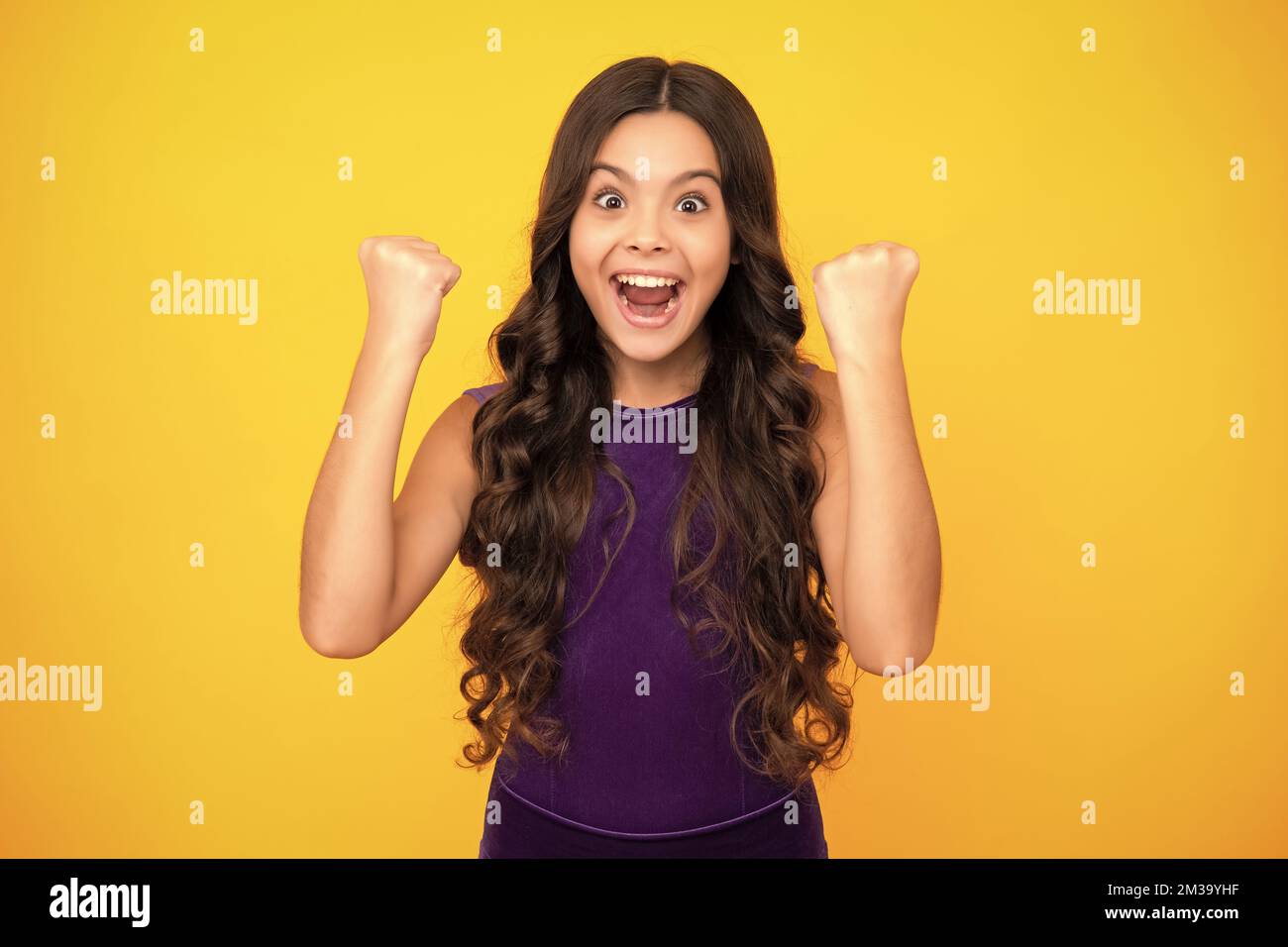 Portrait of teenage girl child doing winner gesture. Kid rejoicing, yes ...