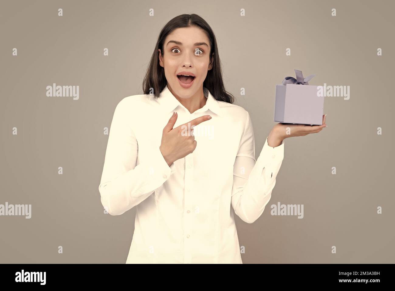 Beautiful girl holding valentines gift. Expressive facial expressions ...