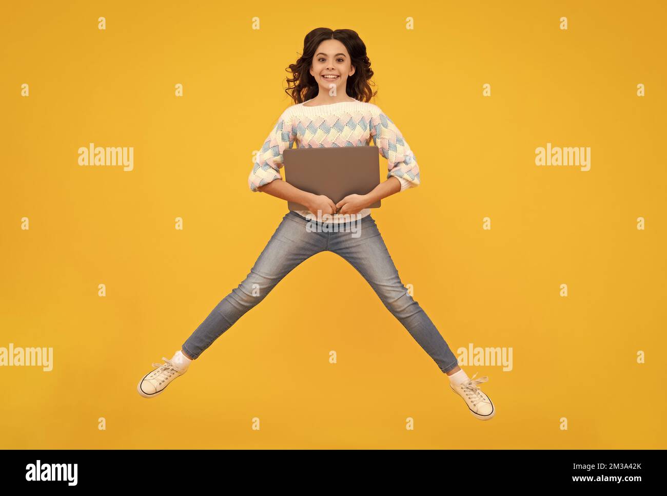 Teenager school girl hold notebook laptop. Run and jump, jumping kids ...