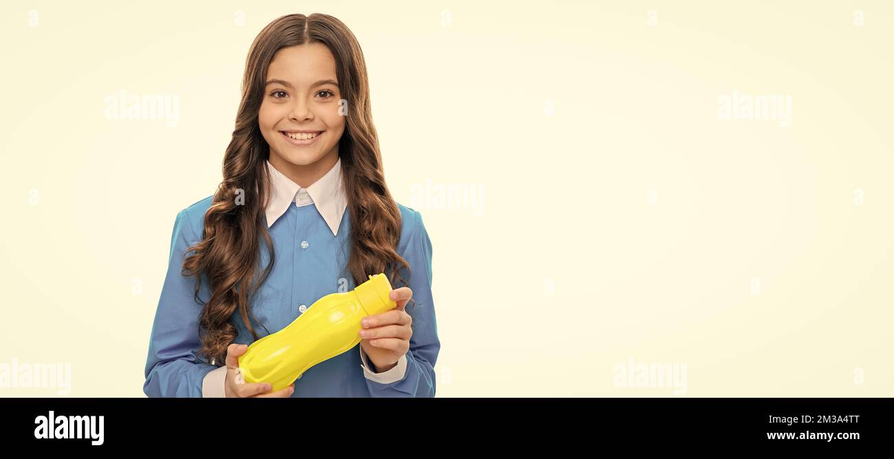 Happy hungry girl hold plastic yellow bottle with drinking yogurt for ...