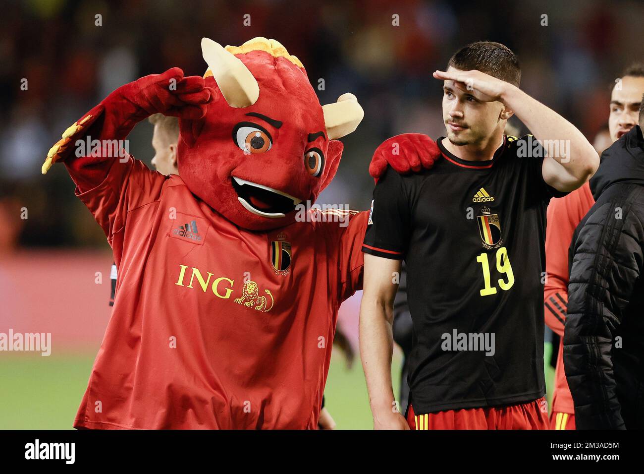 Belgium's Leander Dendoncker celebrates with the mascot after a soccer ...