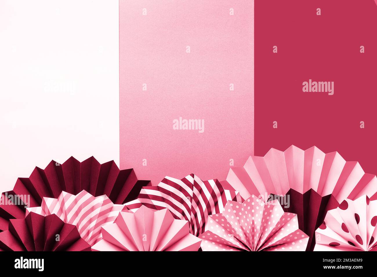 Vibrant frame with folded paper fans, circles on black, pink and white ...