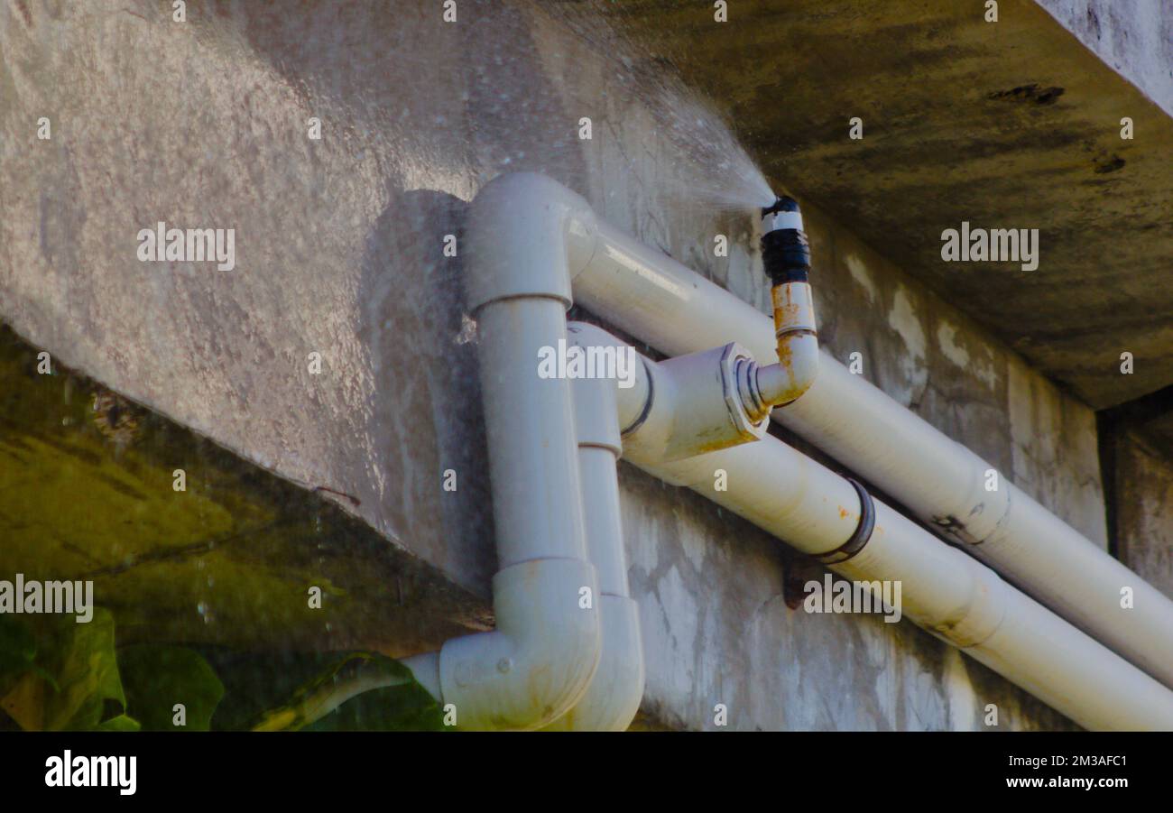 water leak in white pipes under a bridge Stock Photo - Alamy
