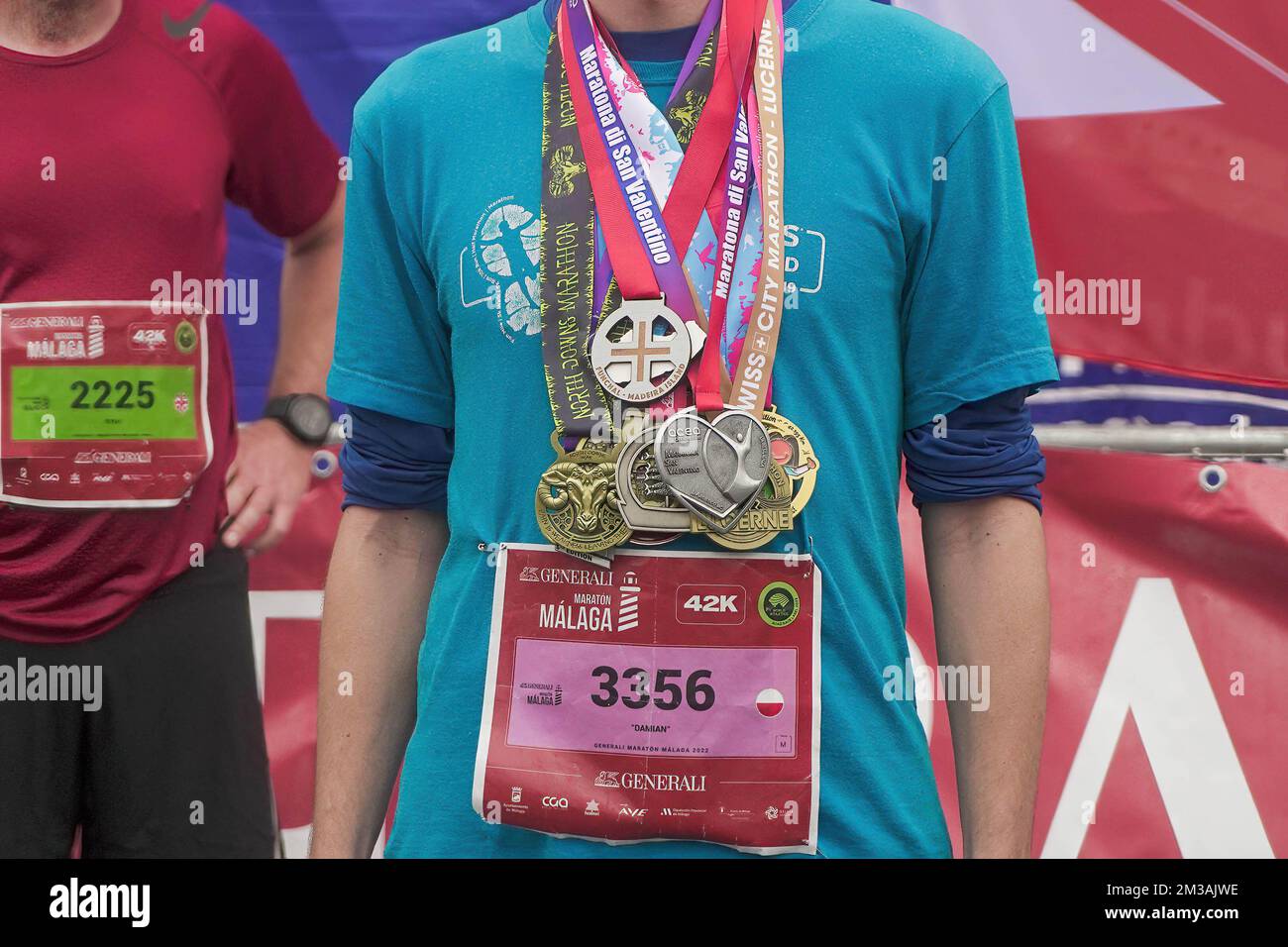 A man wears medals of different marathons during the Generali Marathon ...