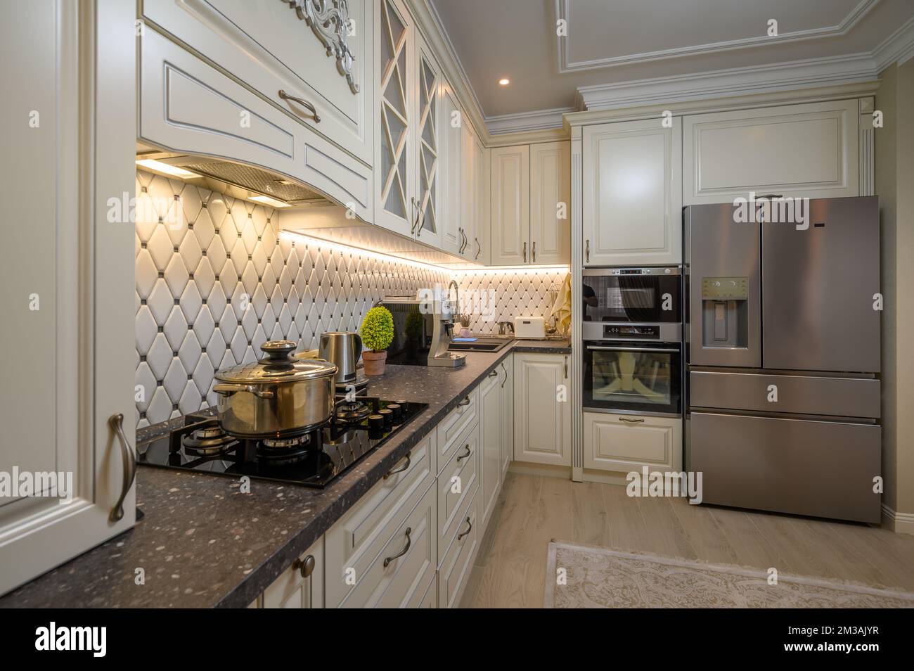 Open-concept kitchen with a beige color scheme and classic design ...