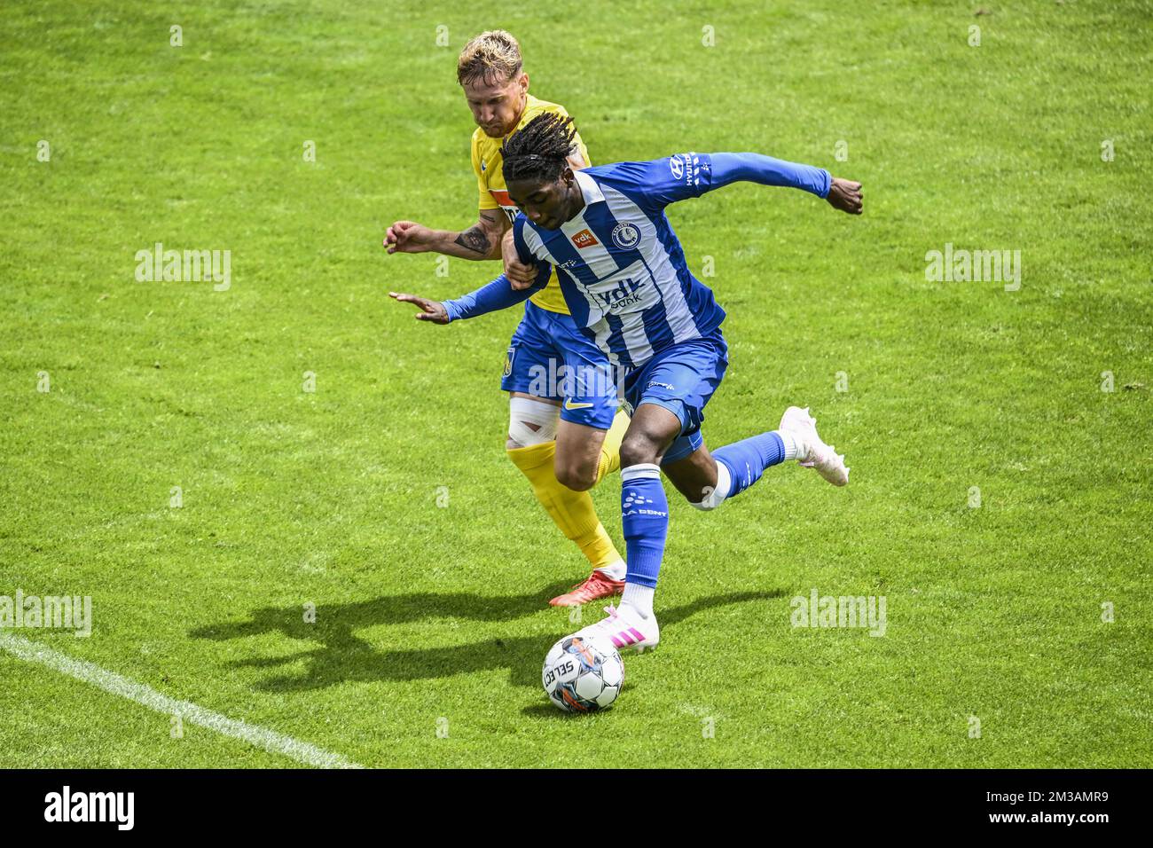 Gent's Justin Munezero and Westerlo's Leo Seydoux pictured in action ...