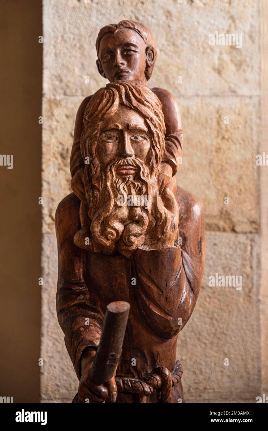 Religious wooden sculpture of a man with a child on his shoulders Stock ...