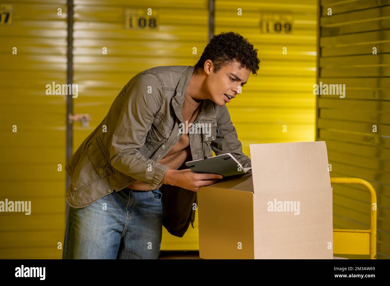 Service man checking the boxes aand looking excited Stock Photo - Alamy