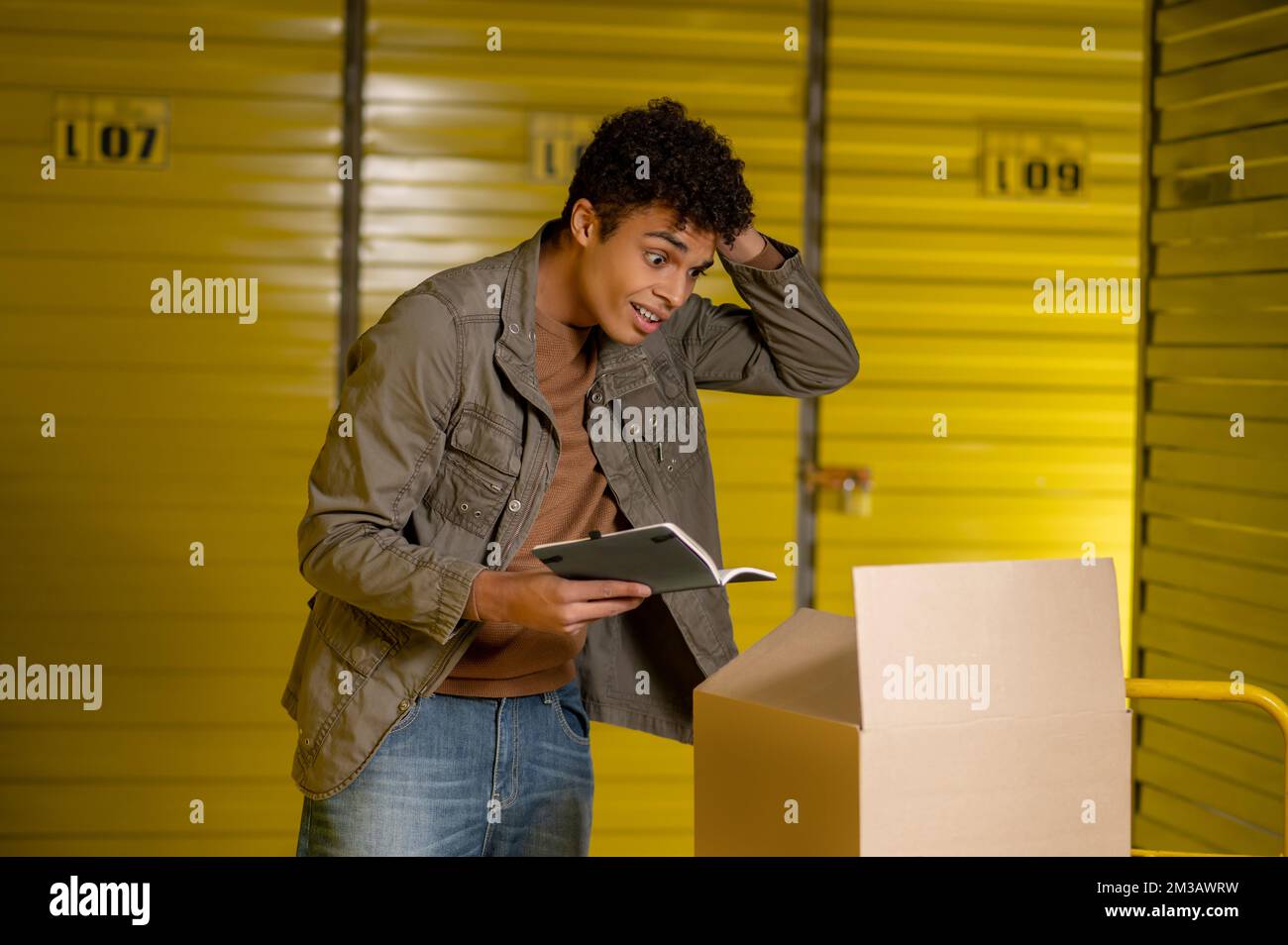 Young man opening locker hi-res stock photography and images - Alamy