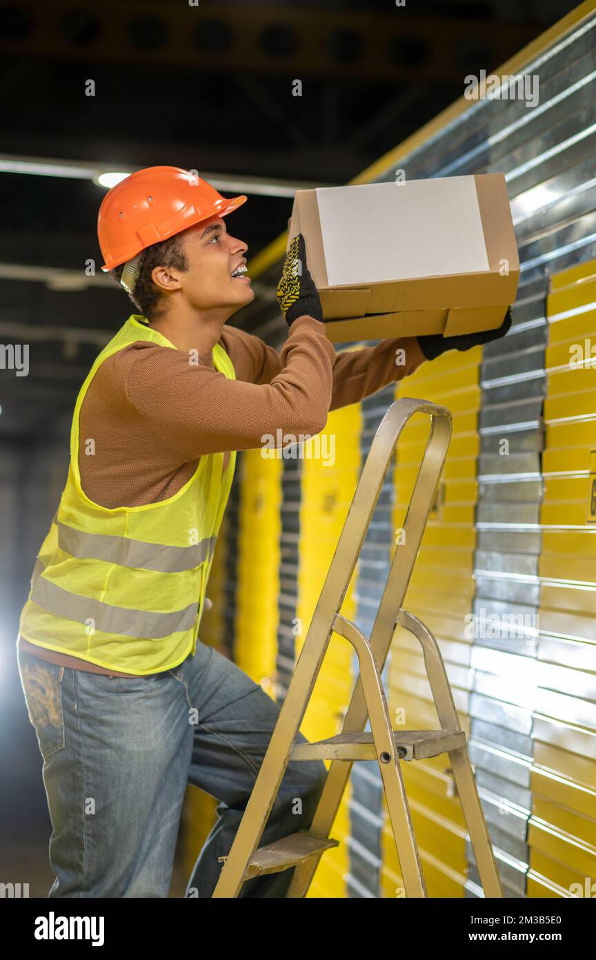 Worker of the warehouse working and looking busy Stock Photo - Alamy