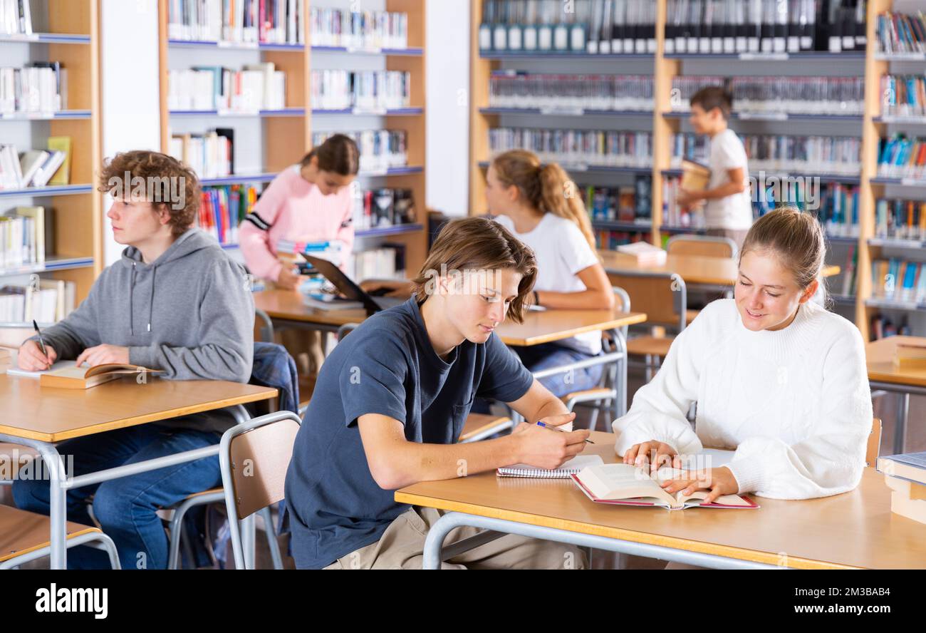 Teenagers spending time in library Stock Photo - Alamy