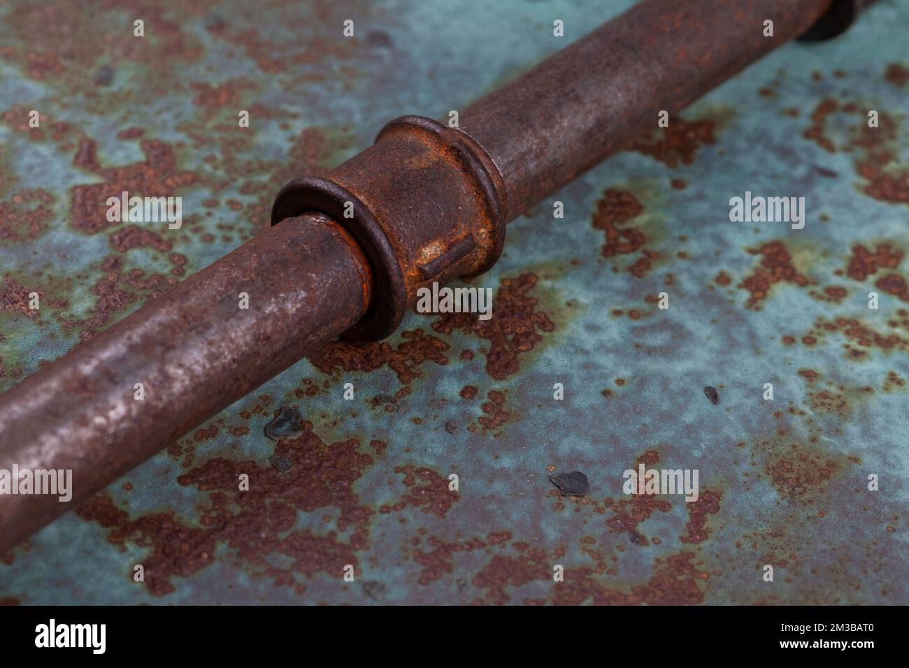 Old rusty valve pipes on rusty metal wall background Stock Photo - Alamy