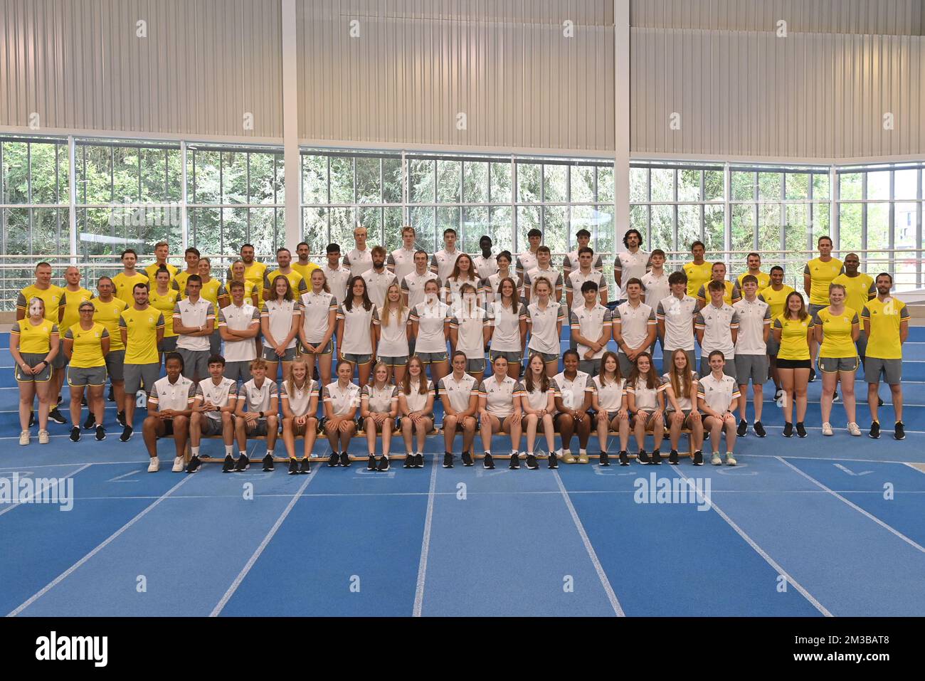 Athletes and staff pose for a family photo at a team building exercise ...
