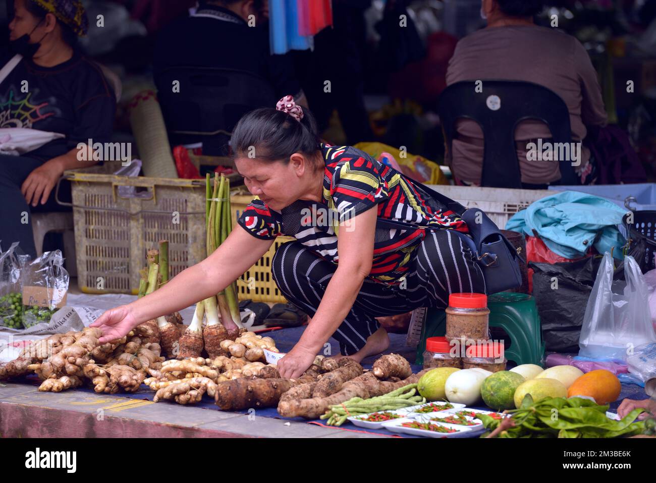 An indigenous Bajau woman selling food at the Sunday market in Kota ...