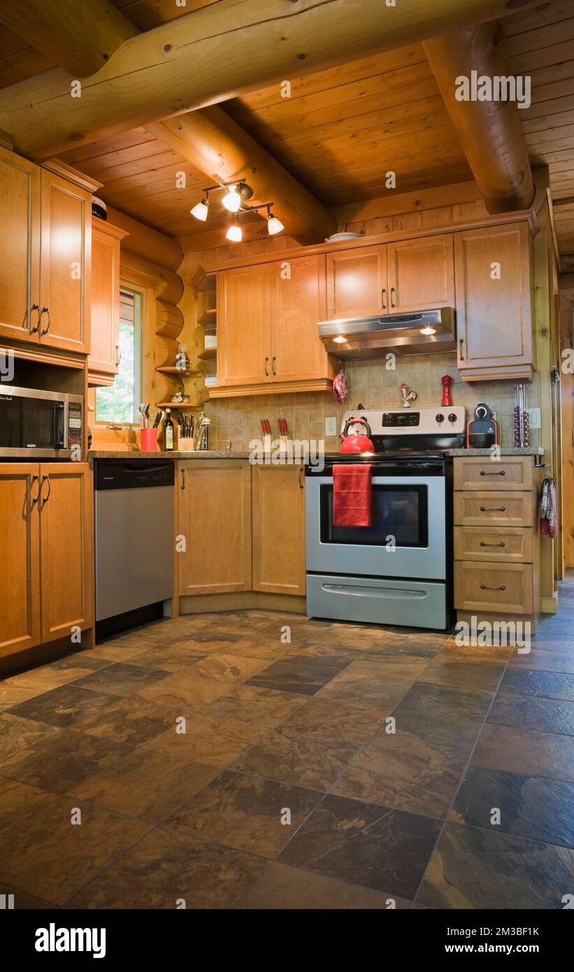 Wooden shaker style cabinets and modern appliances in kitchen with ...