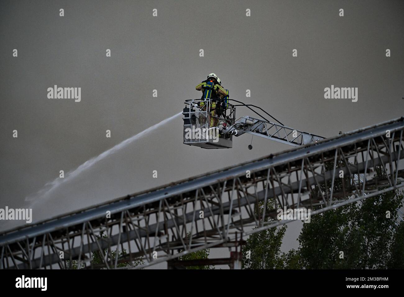 Fire fighters pictured in action at the scene of a fire at waste ...
