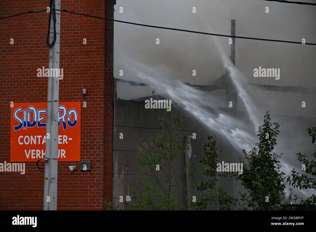 Fire fighters pictured in action at the scene of a fire at waste ...