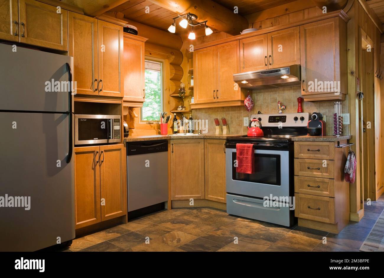 Wooden shaker style cabinets and modern appliances in kitchen with ...