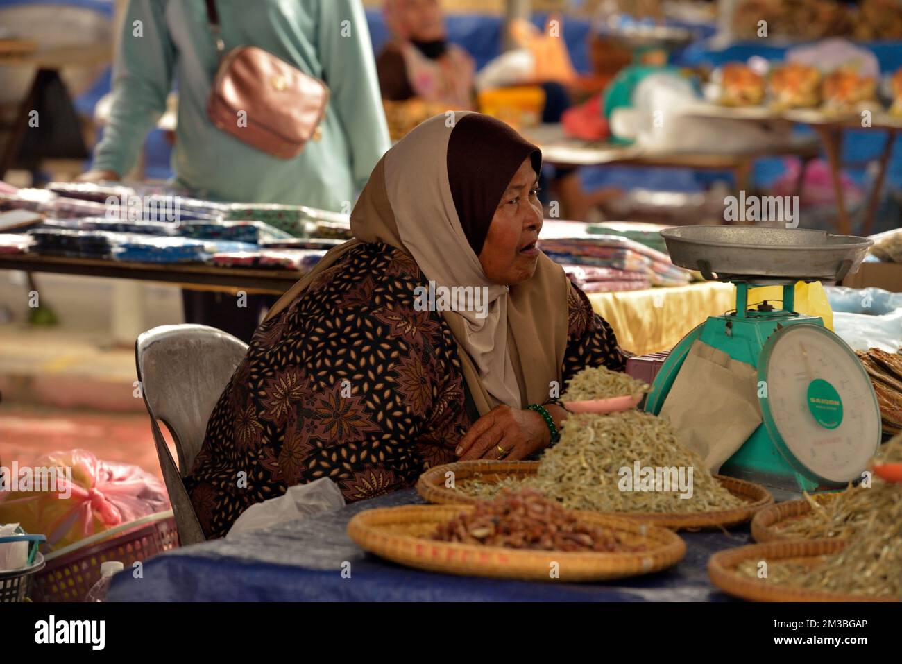 An indigenous Bajau woman selling food at the Sunday market in Kota ...