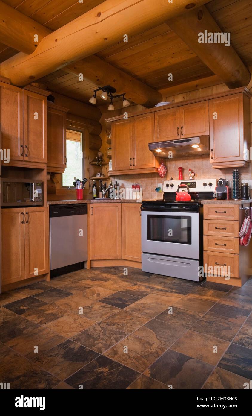 Wooden shaker style cabinets and modern appliances in kitchen with ...