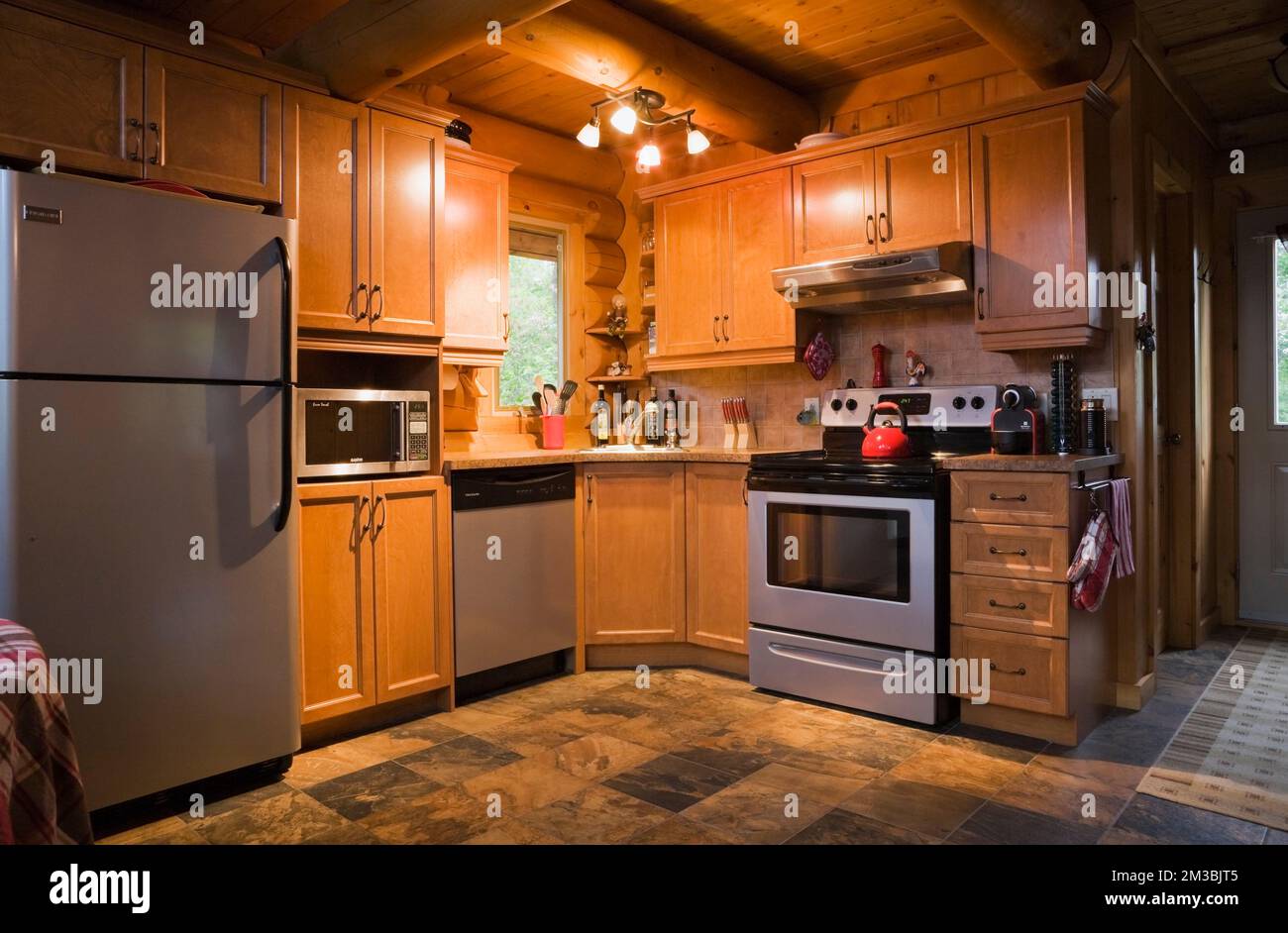 Wooden shaker style cabinets and modern appliances in kitchen with ...