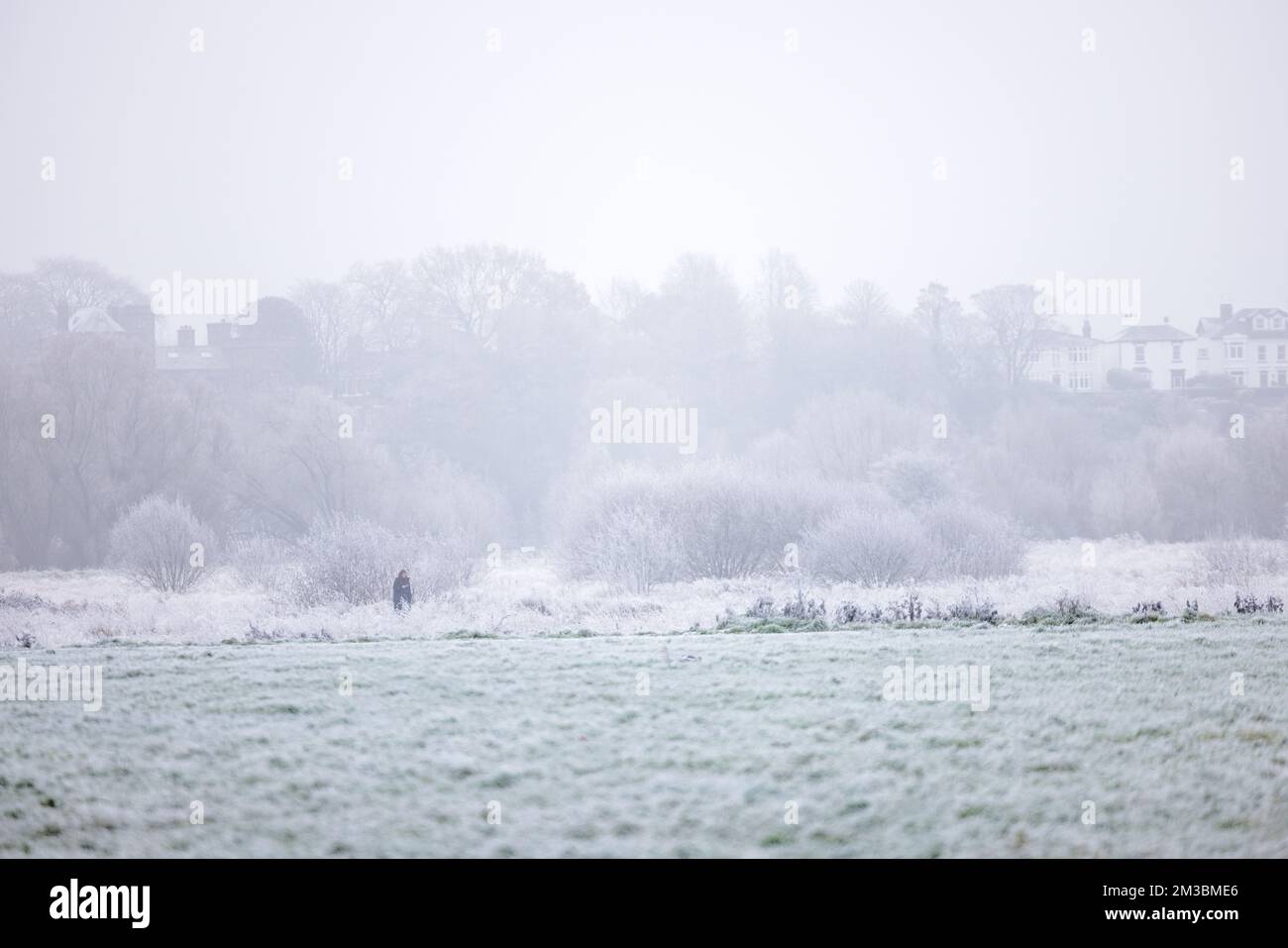 Chester, UK. 12th Dec, 2022. A lone walker makes her way through the ...